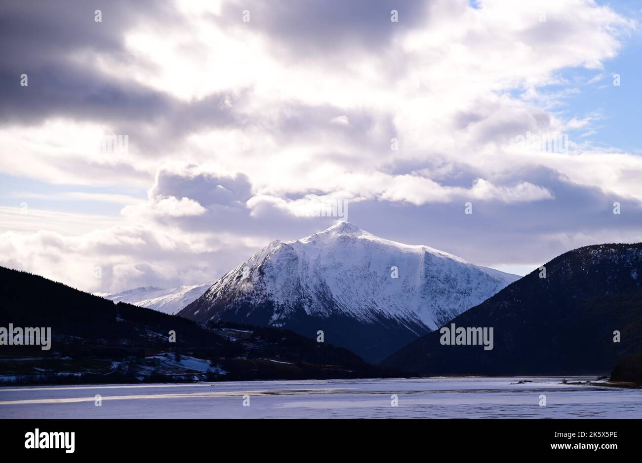The mountain Lomseggen with its peak covered in snow in Lom National ...