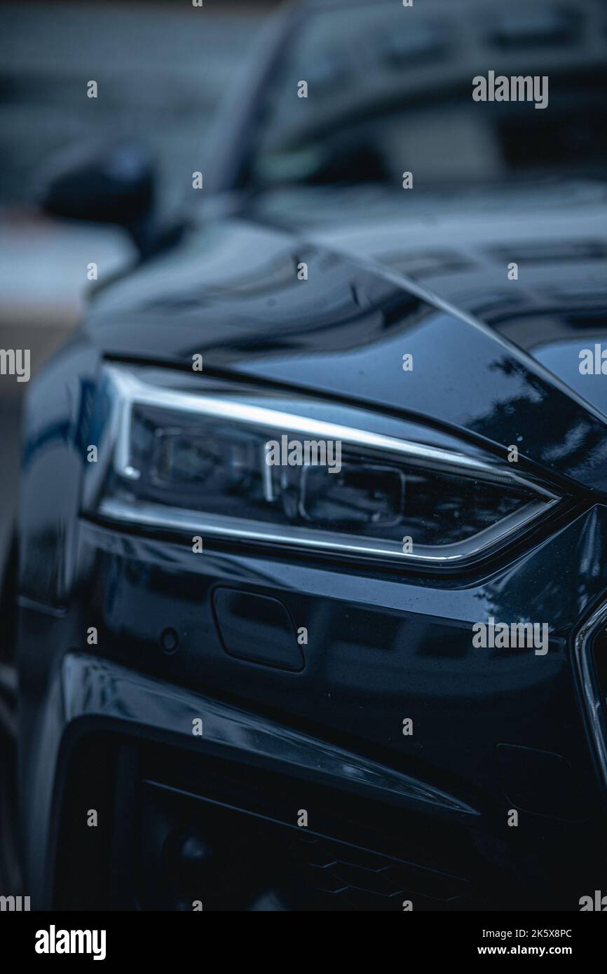 The vertical view of a black car's frontal beam light Stock Photo - Alamy