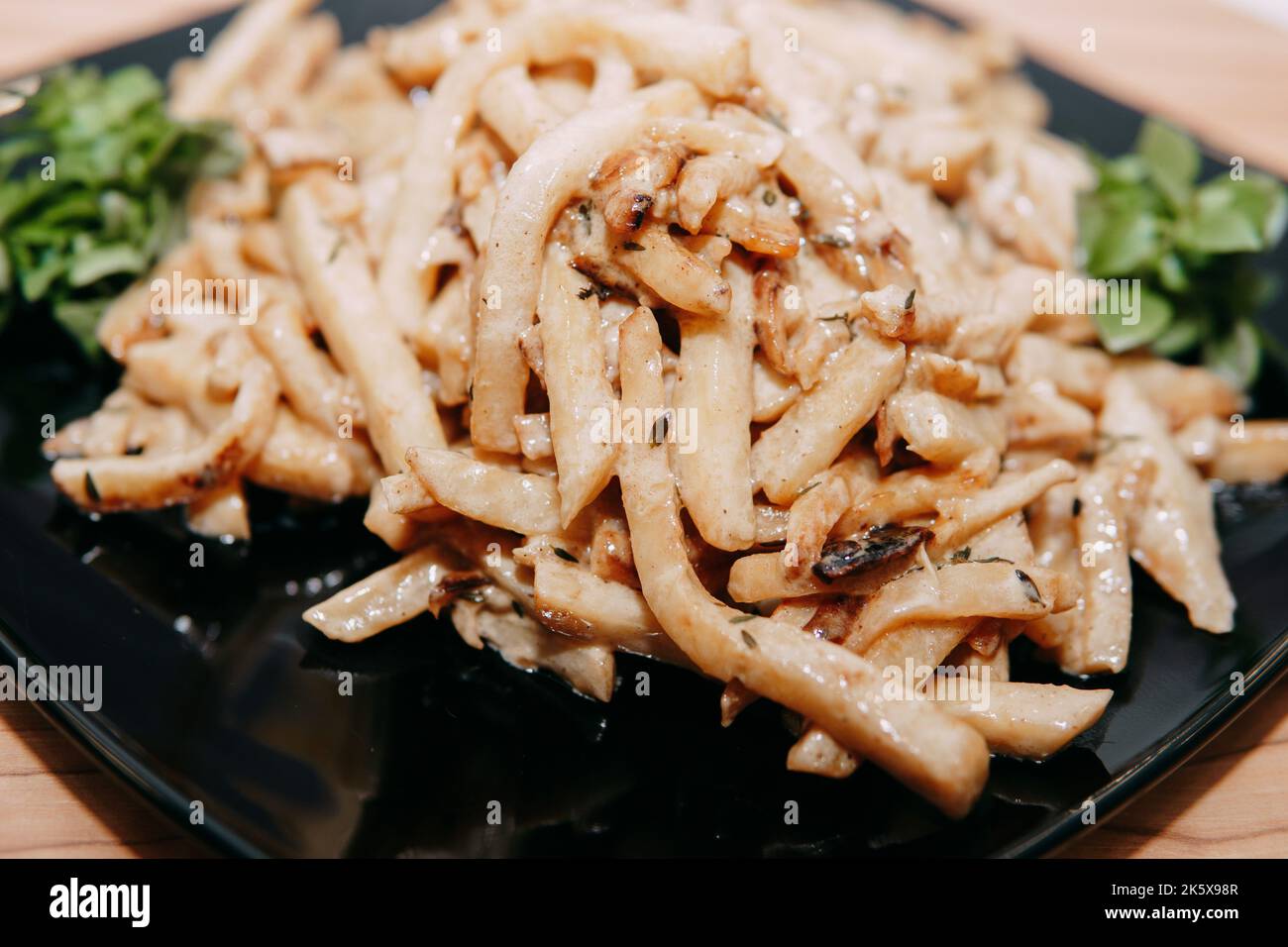 Preparing a side dish of celery root in a cooking class. Cooking at ...