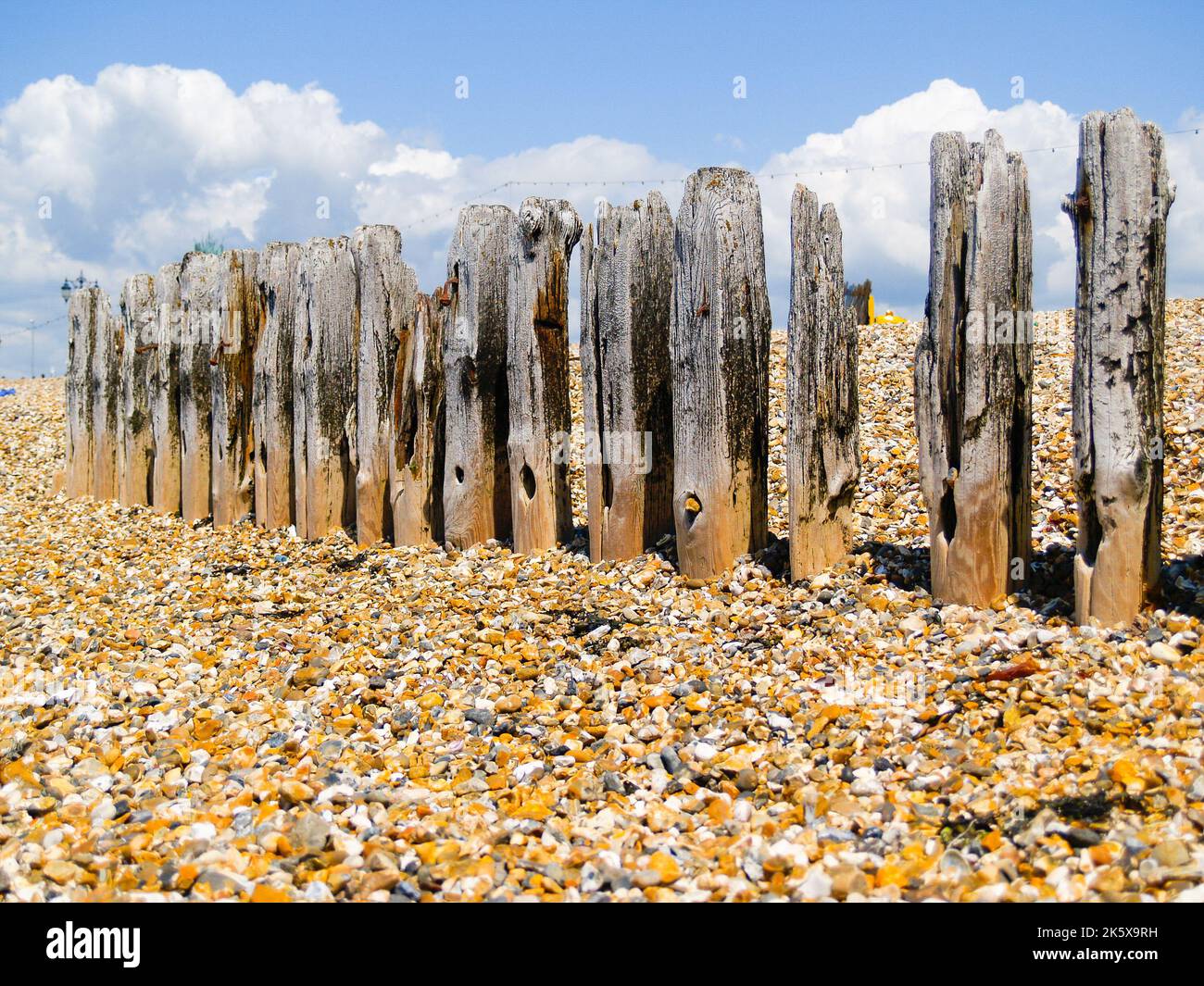 Old weathered breakwater posts in stony beach at Plymouth waterfront in ...
