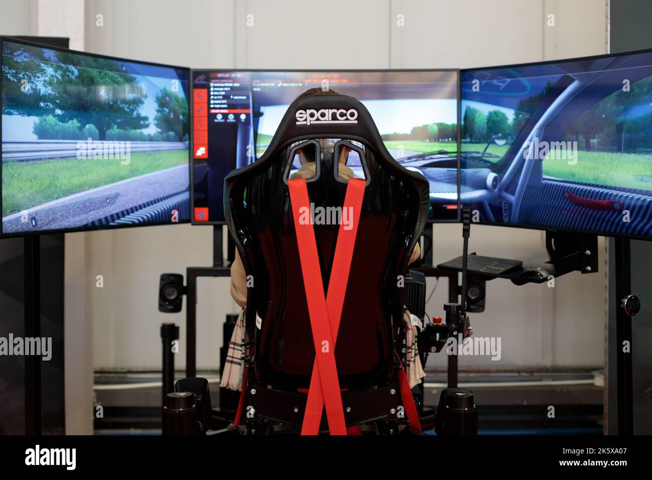 Poland, Poznan - October 09, 2022: People play a racing simulator at ...