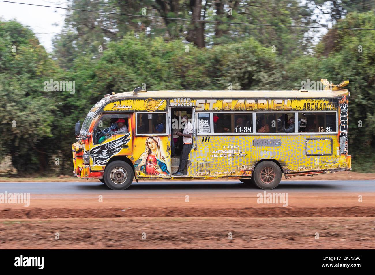 A bus with custom paintwork driving along Ngong road near the junction ...