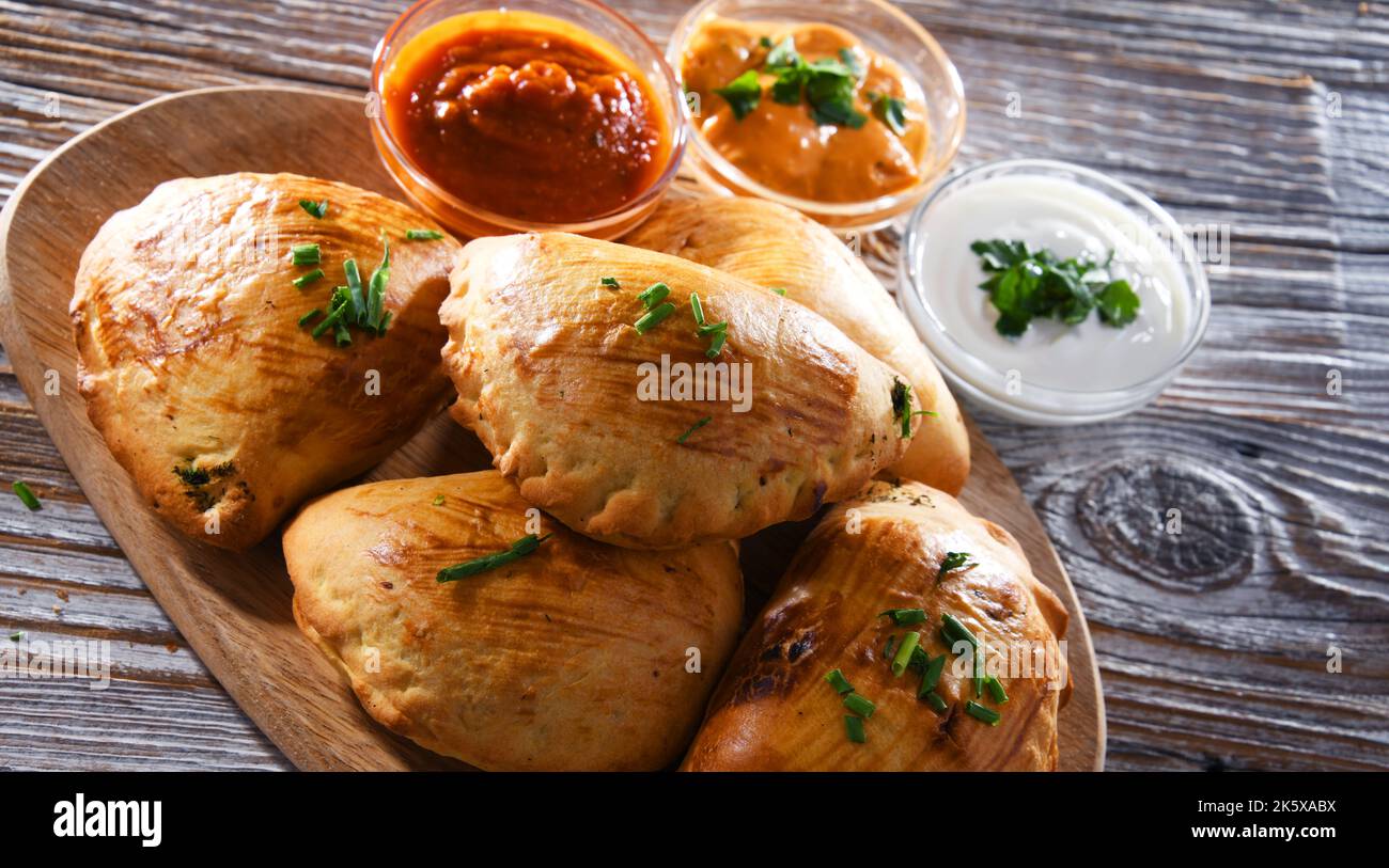 Composition with a dish of oven-baked pierogi Stock Photo - Alamy