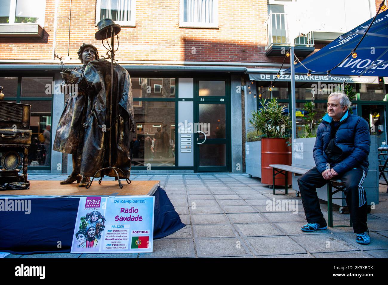 A man is seen watching an artist performing during the World Living ...
