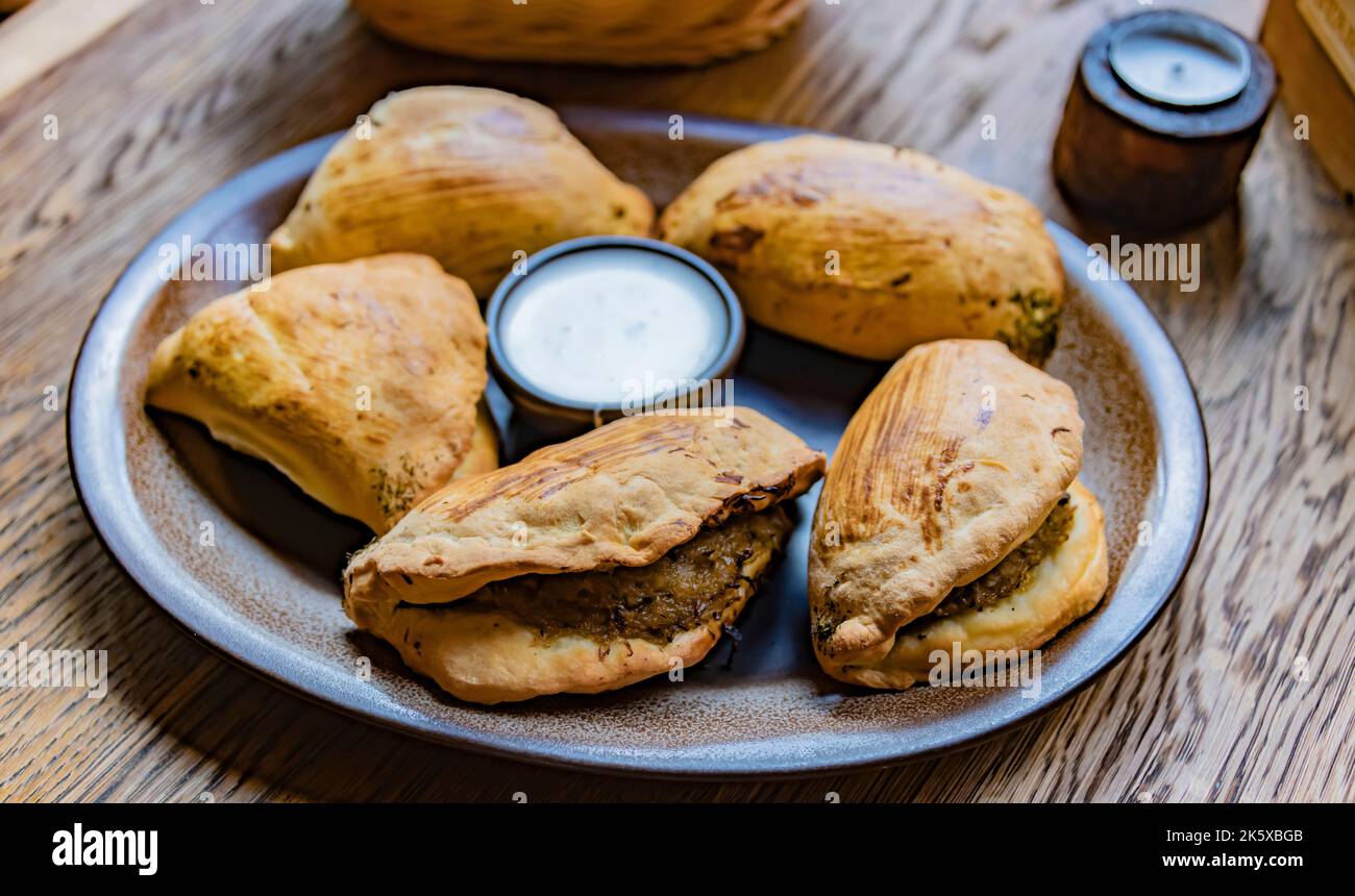 A plate of oven-baked pierogi on a restaurant table Stock Photo - Alamy
