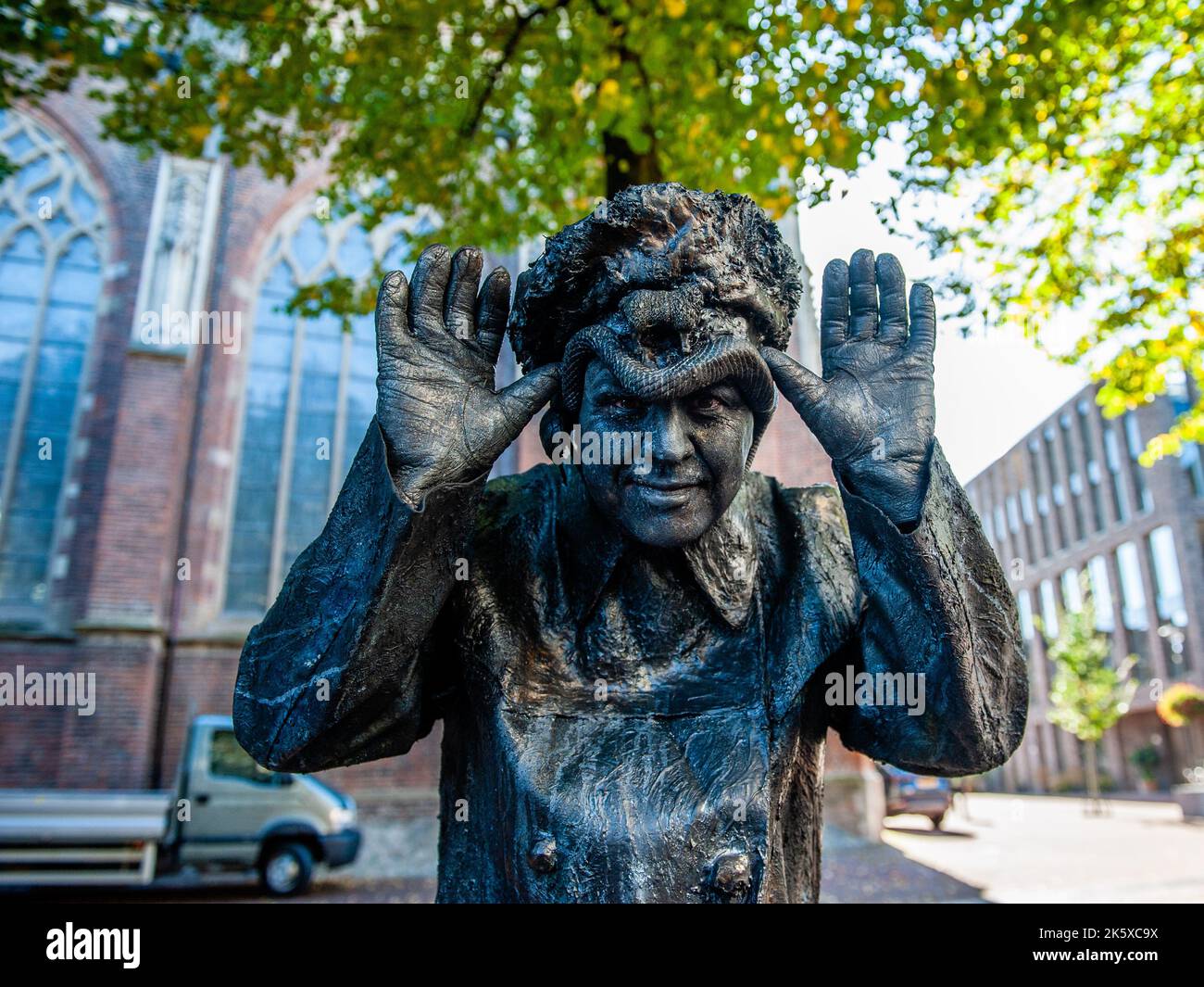 An artist poses for the camera while performing as a living statue. The ...