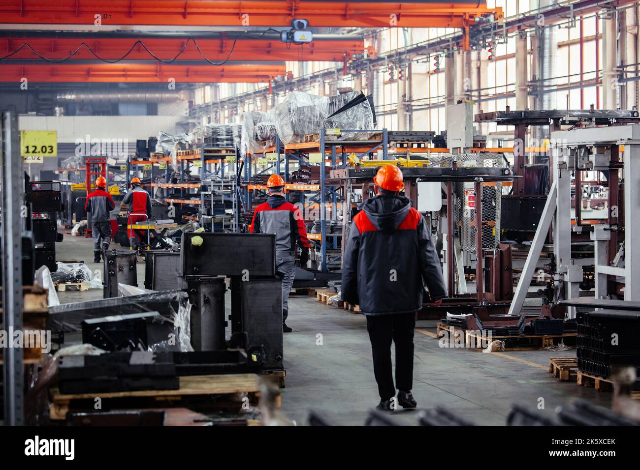 Industrial warehouse. Shelves with packs of goods and workers Stock ...