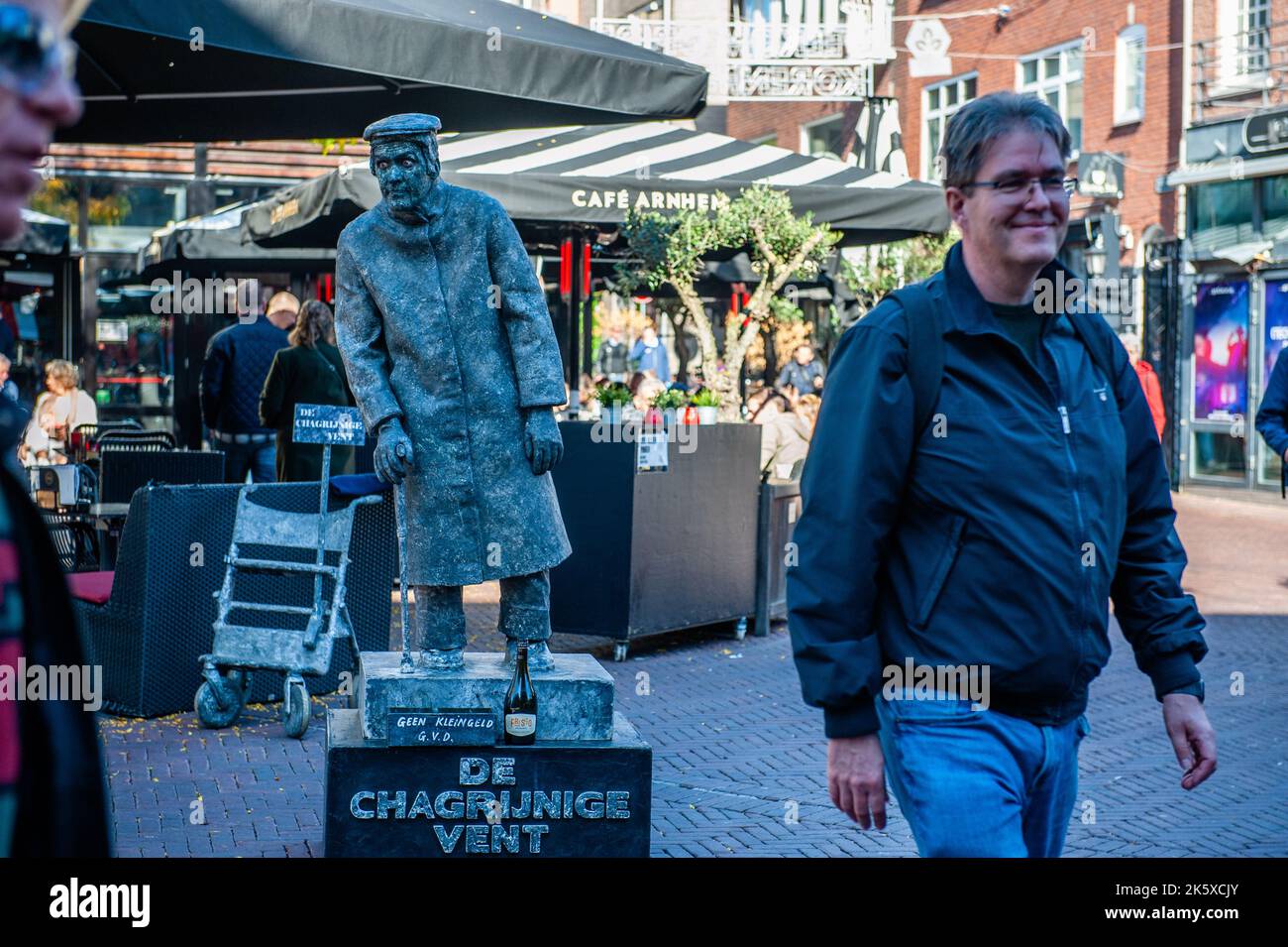 A man performing as a living statue is seen looking to the audience ...