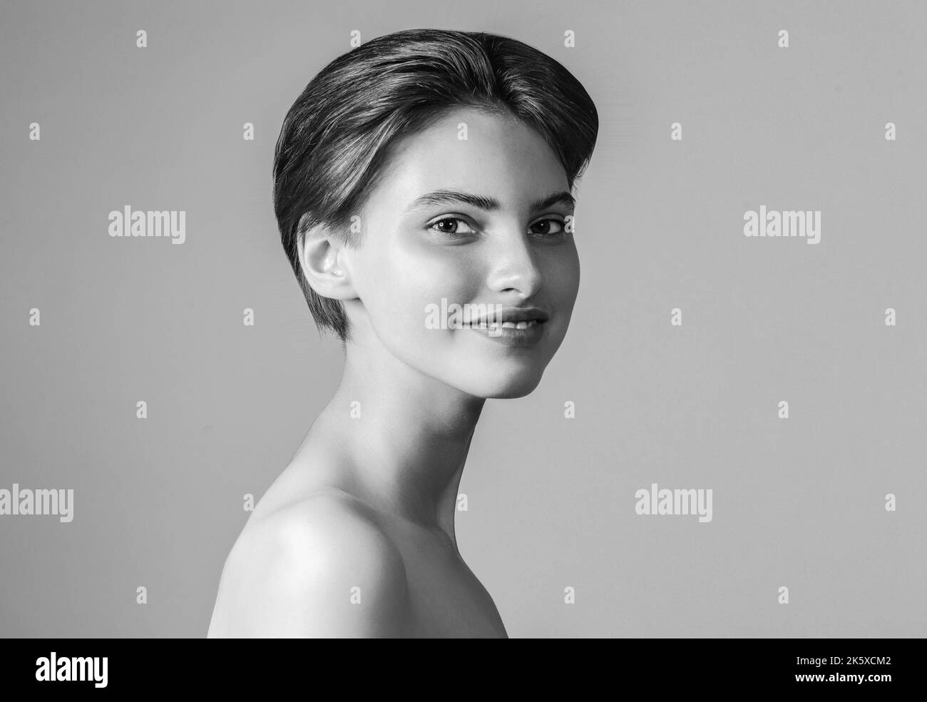 Monochrome portrait of a beautiful young smiling woman with absolutely ...