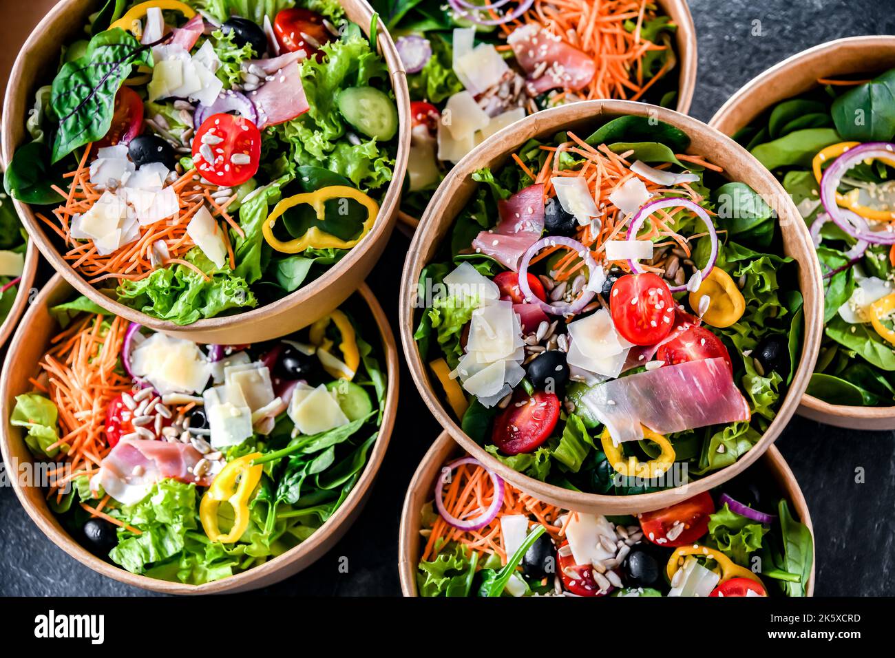 Round paper boxes with pre-packaged vegetable salads ready for sale ...