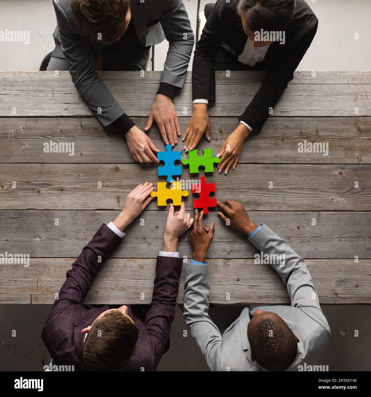Diverse team people assembling jigsaw puzzle, multiracial group of ...