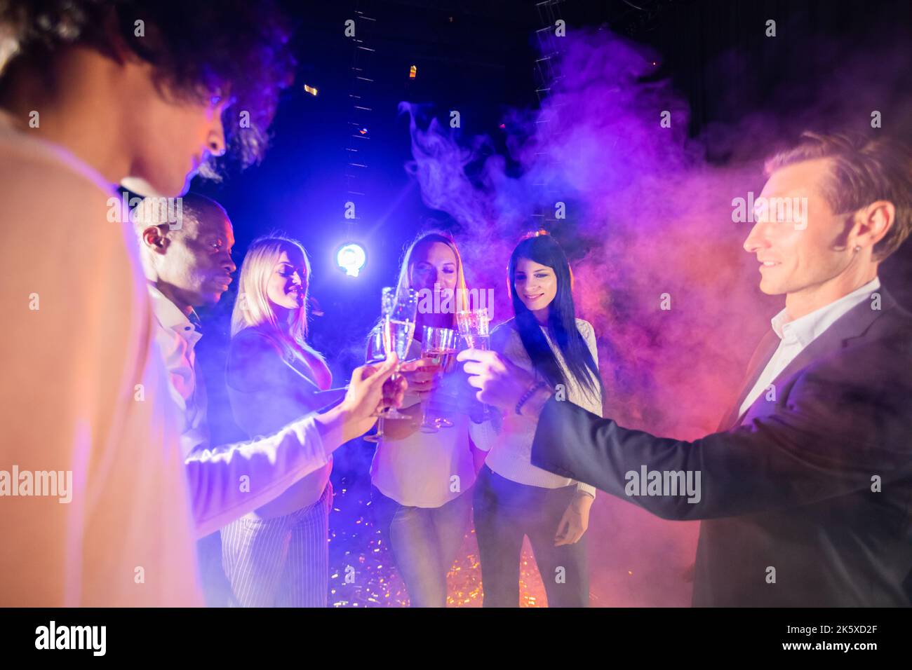 Group of friends dancing in nightclub celebrating with champagne Stock ...