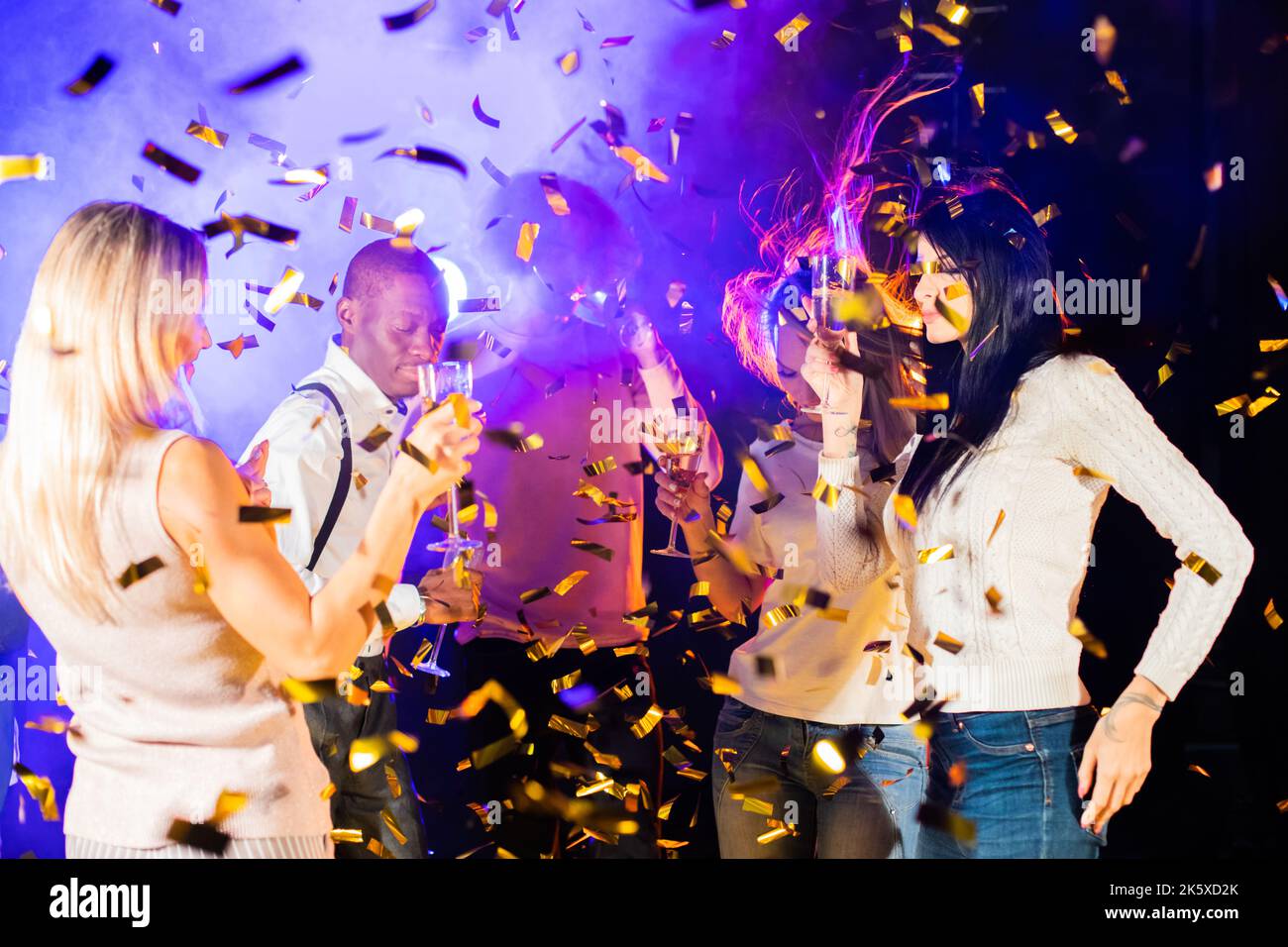 Group of friends dancing in nightclub celebrating with champagne Stock ...