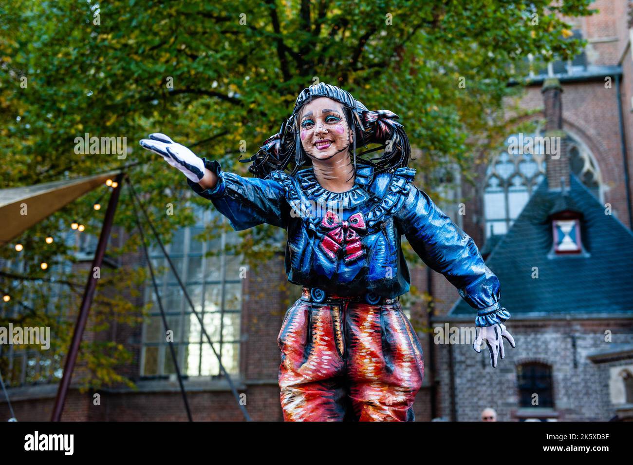 A woman is seen performing as a living statue on the street during the ...