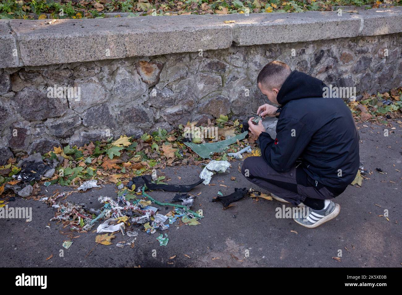 Kyiv, Ukraine. 10th Oct, 2022. A man examines fragments of a rocket at ...