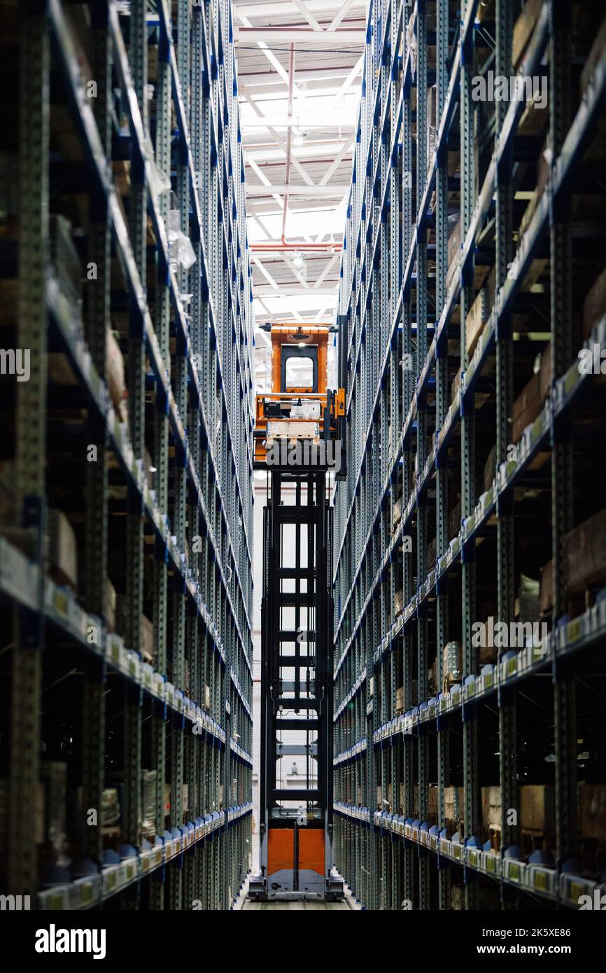 Modern warehouse interior with shelves and boxes and forklift loader ...