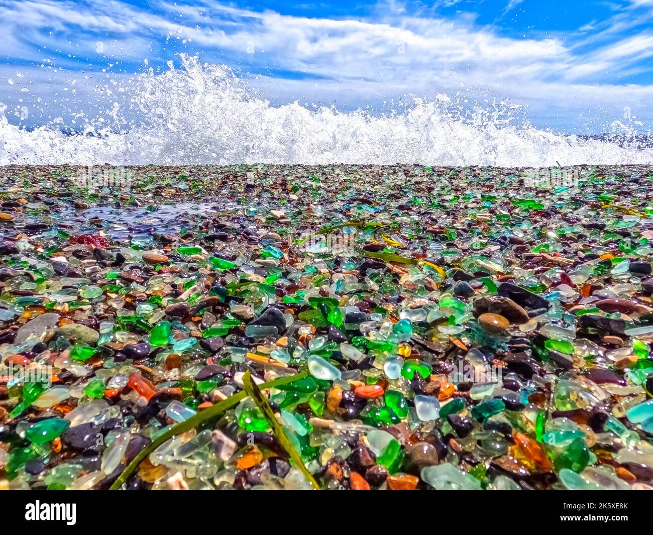 Natural polish textured sea glass and stones on the seashore. Azure ...