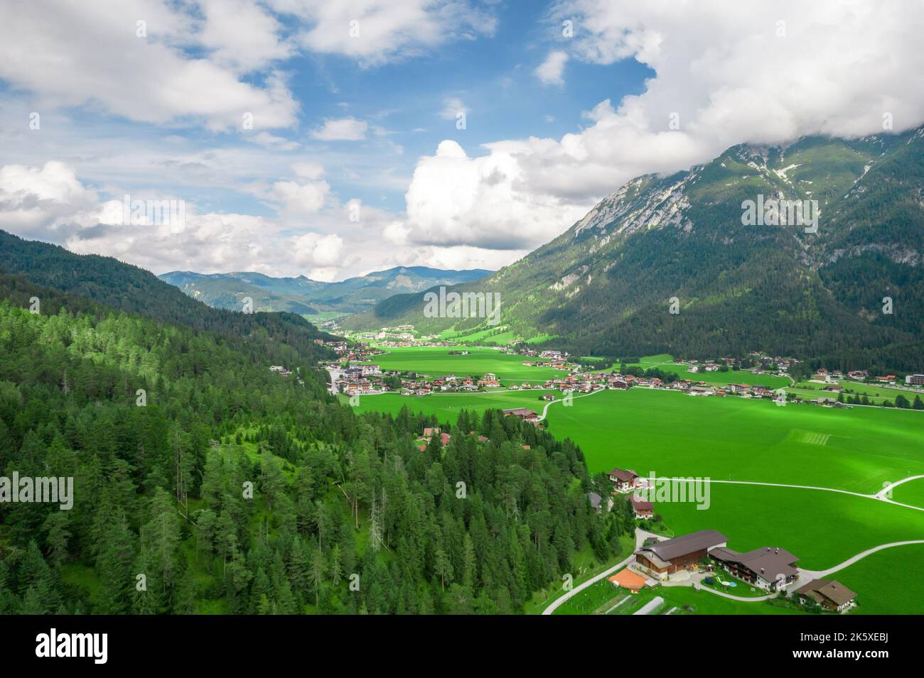 An aerial view of houses and buildings in lush green Tyrol, Austria ...