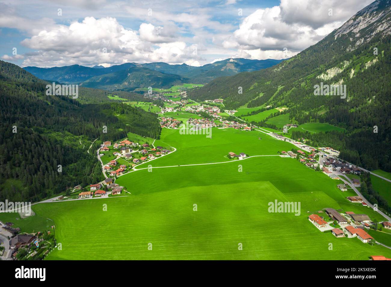 An aerial view of houses and buildings in lush green Tyrol, Austria ...