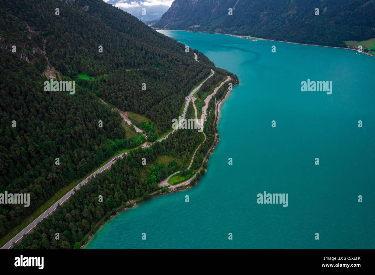 An aerial view of Achen Lake between lush green steep mountains in ...