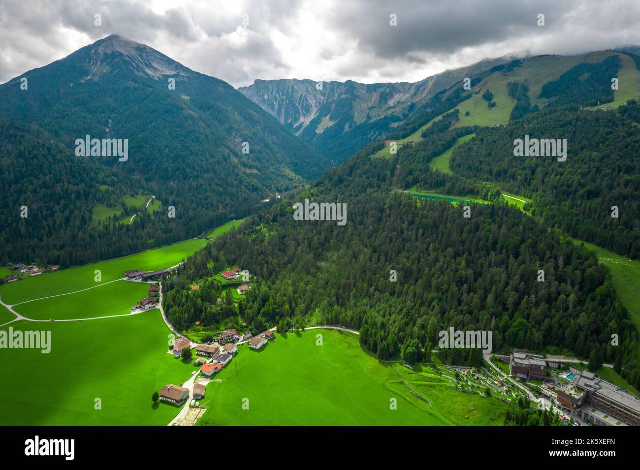 An aerial view of houses and buildings in lush green Tyrol, Austria ...