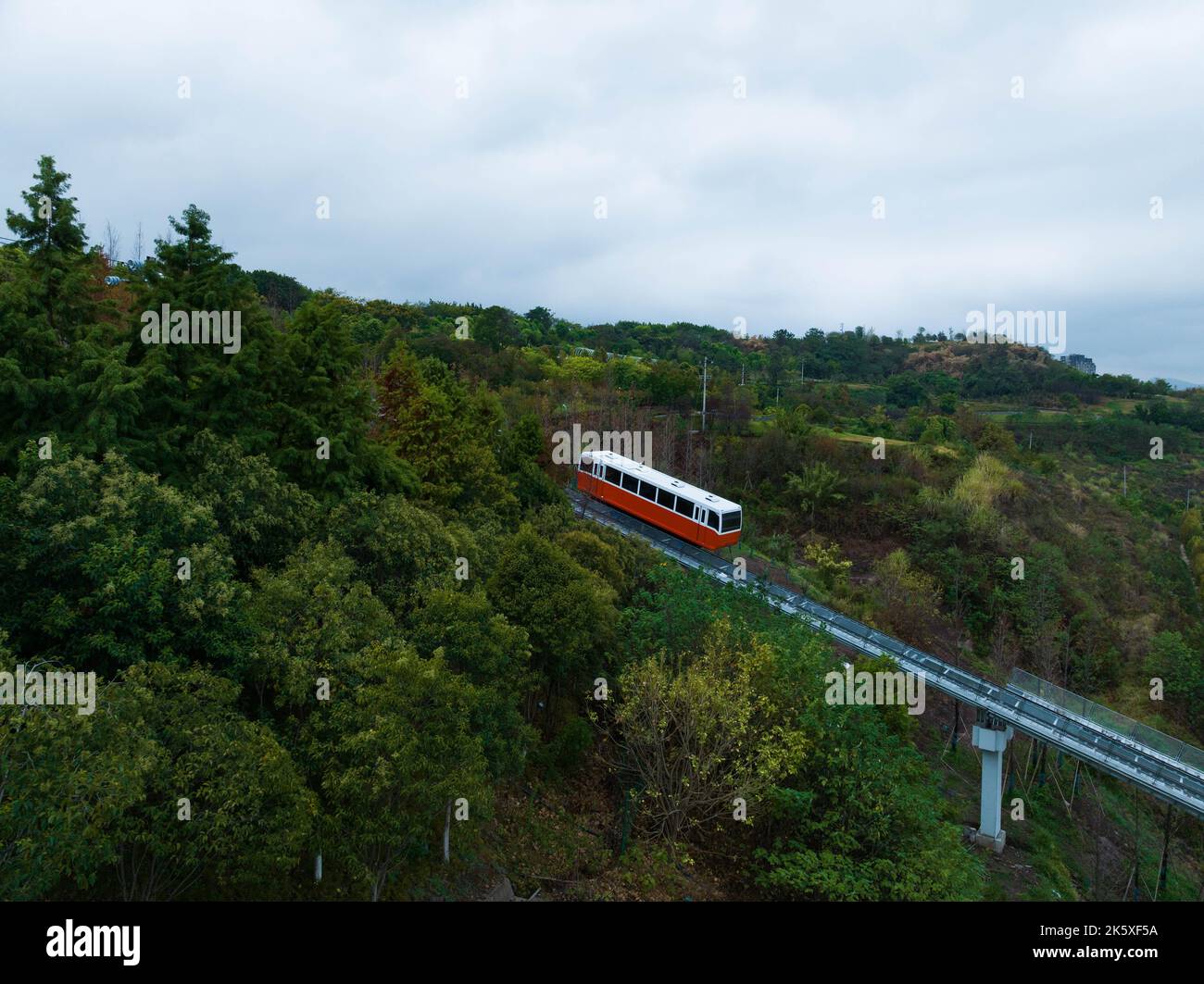 An aerial view of a funicular train in Penang Hill on a cloudy day ...