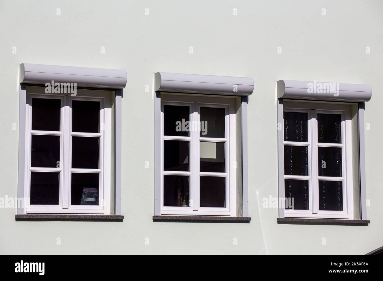 New muntin windows with front-mounted roller shutters on a renovated ...