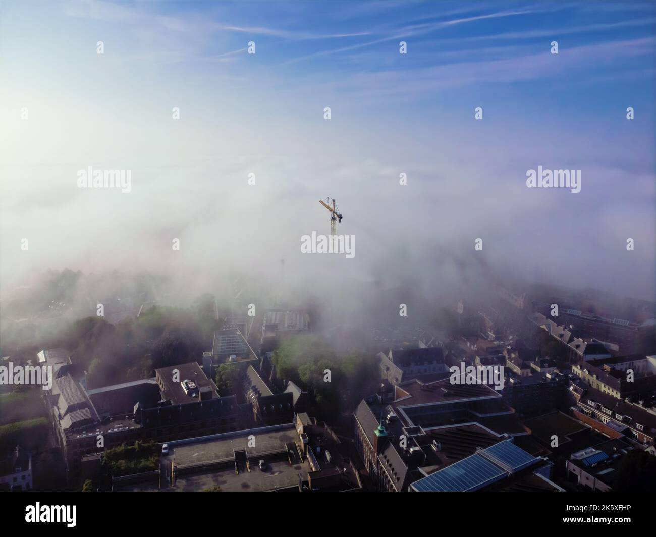 An aerial view of a city covered in a mist Stock Photo - Alamy