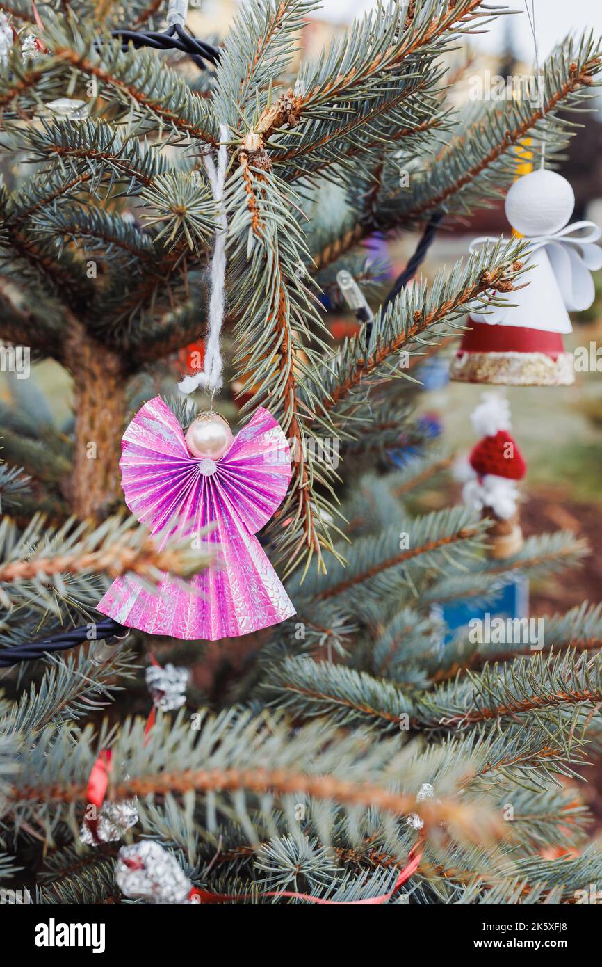 Handmade angel decoration of paper and pearl bead on Christmas tree ...