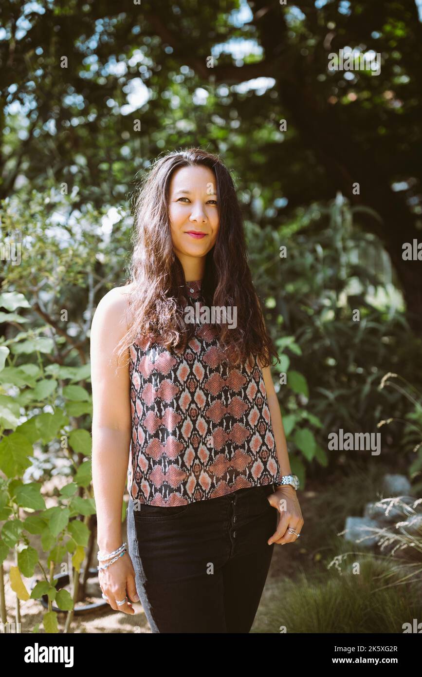 Beautiful young happy mixed race Japanese woman in jeans and shirt in ...