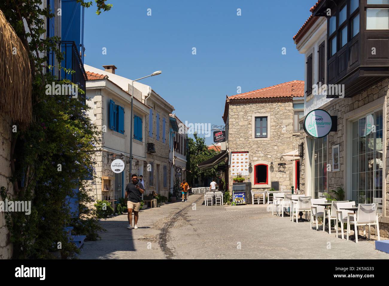 View of people walking on street and old, historical, traditional stone ...