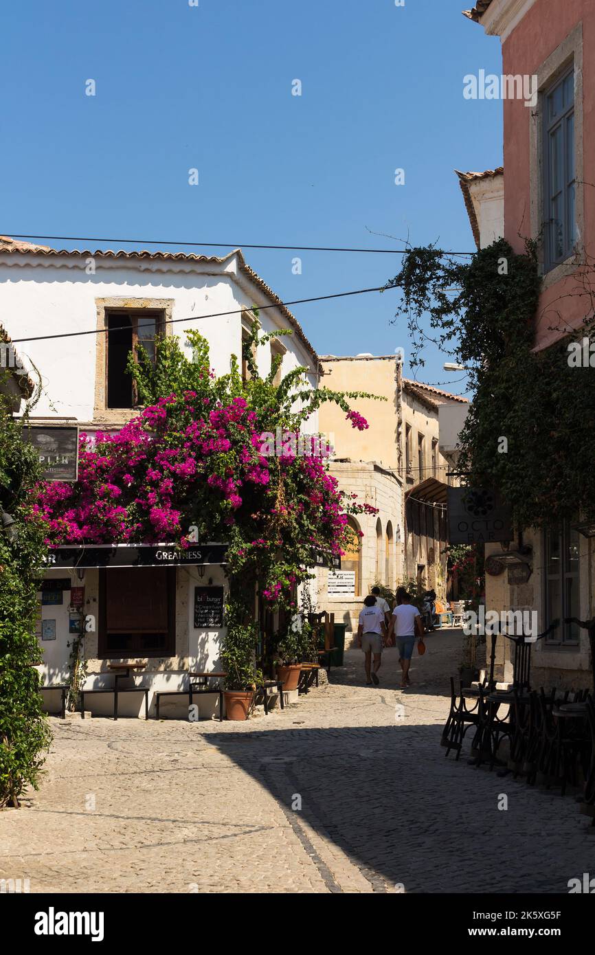 View of people walking on street and old, historical, traditional stone ...