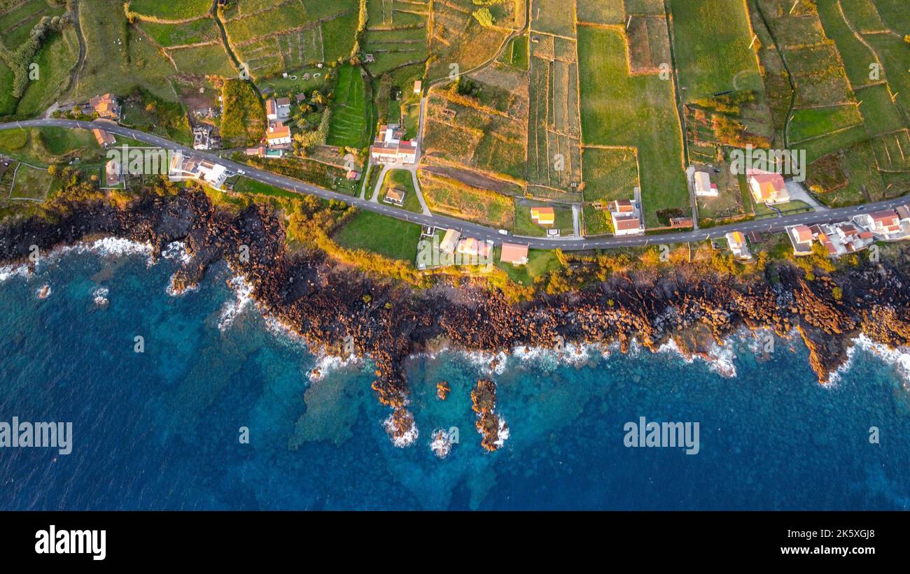 Drone photo of the coastline, showing the countryside, some houses and ...