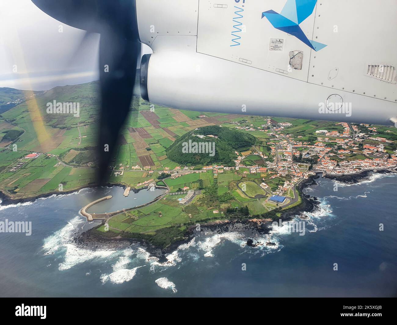 The Azores and ocean from the plane with the propeller in the shot ...