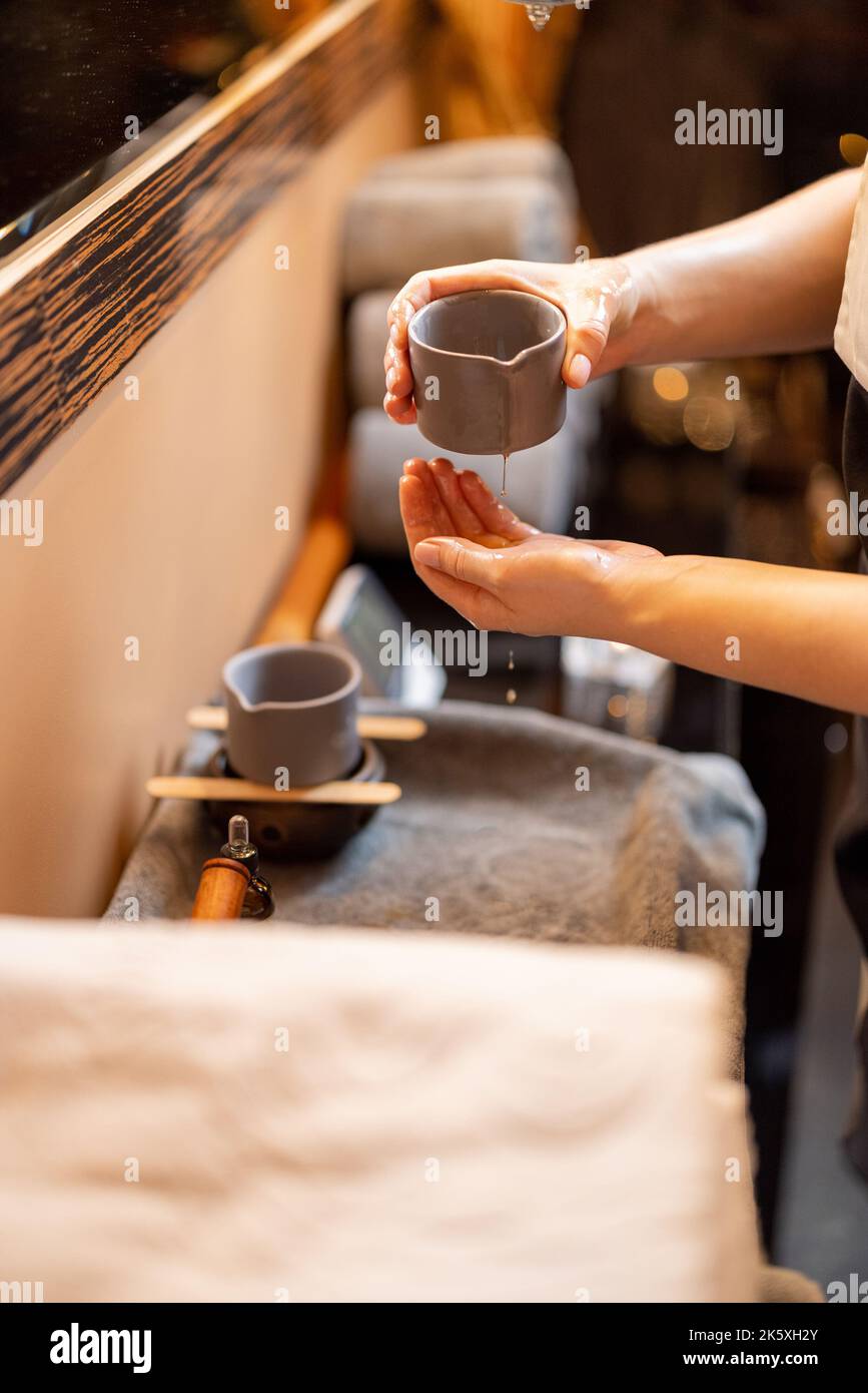 Woman hands applying oil hi-res stock photography and images - Alamy
