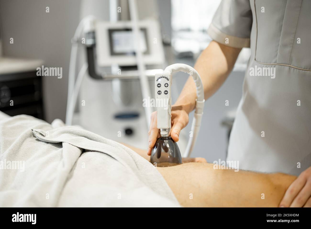 Applying vacuum roller massage on leg Stock Photo - Alamy