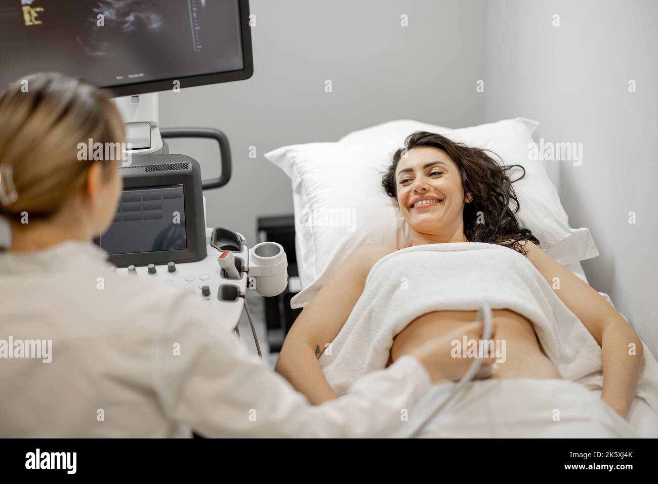 Woman during an ultrasound examination of abdominal cavity Stock Photo ...