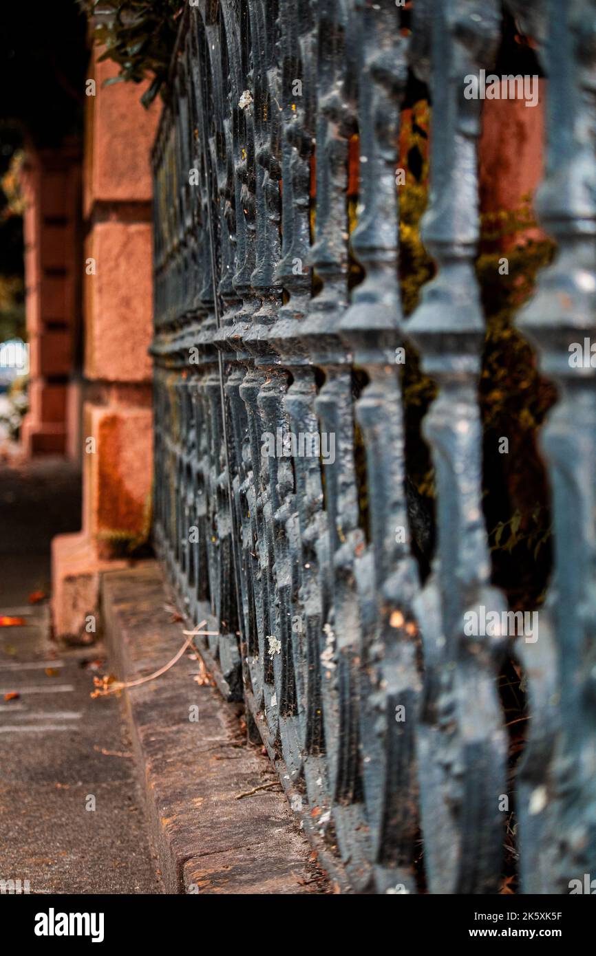 A vertical shot of a fence on a red stone building Stock Photo - Alamy
