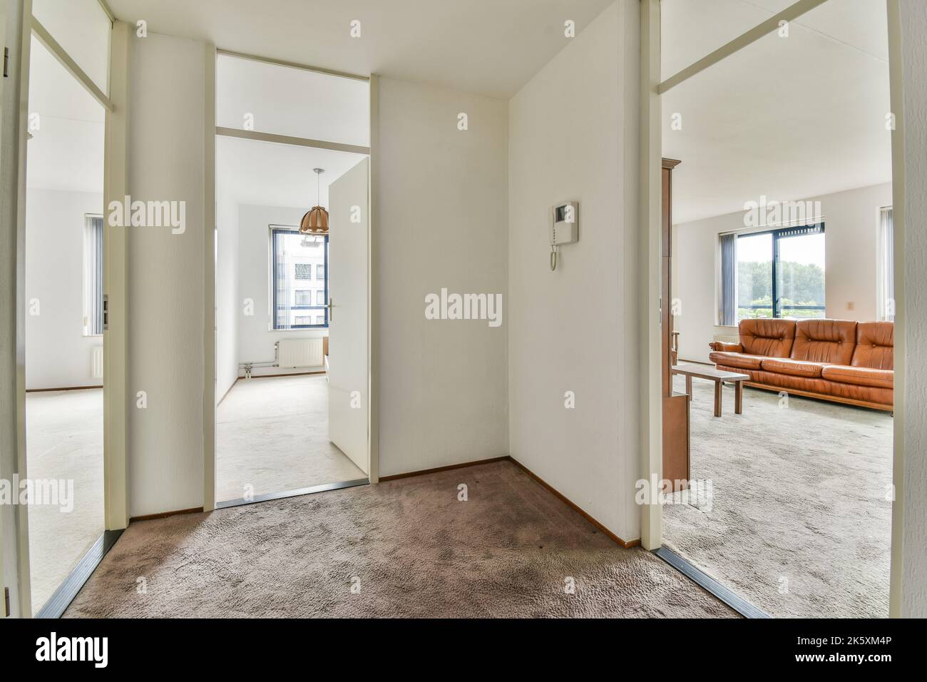 Interior of narrow corridor with telephone in daylight Stock Photo - Alamy