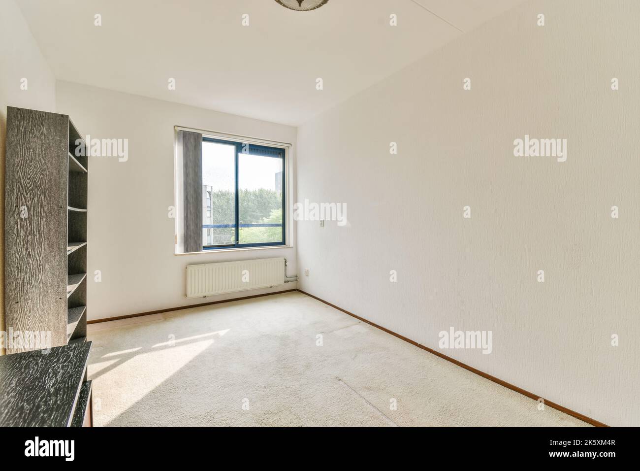 A cozy and spacious empty room with working desk and cupboard Stock ...