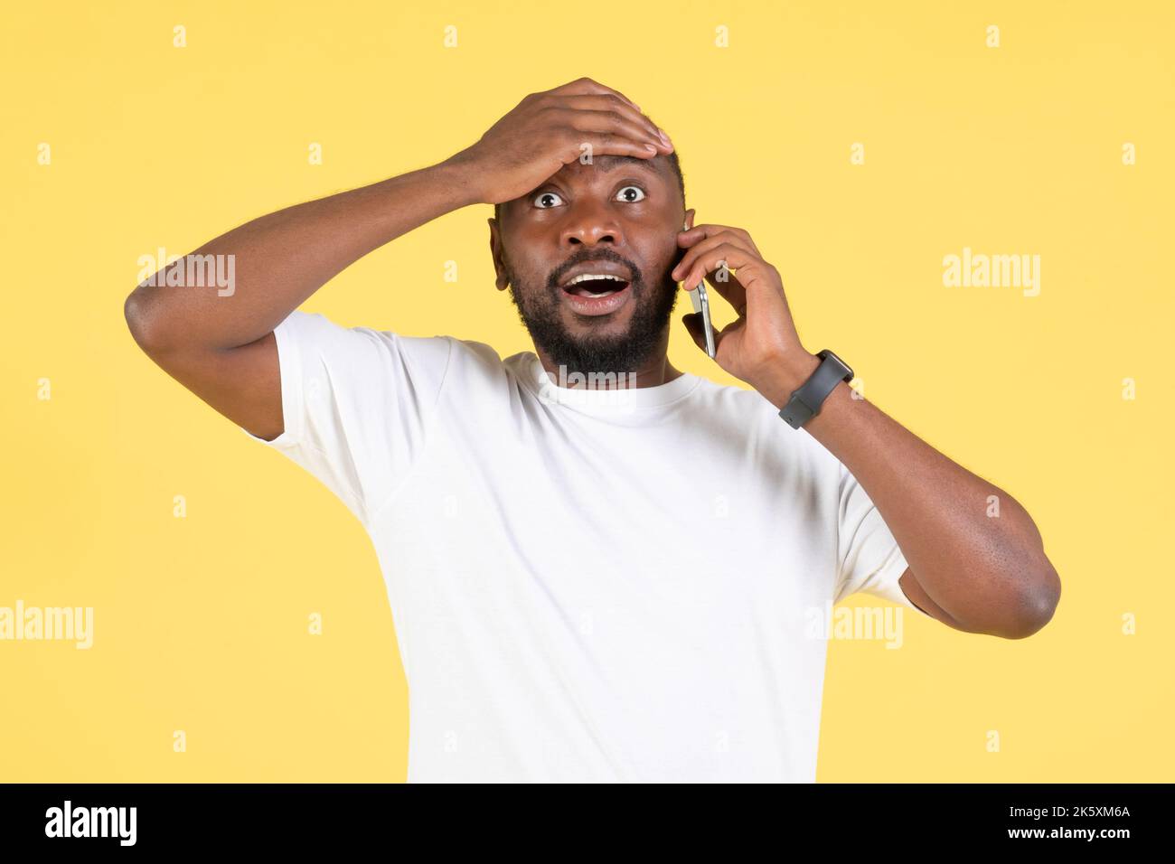 African American Guy Talking On Cellphone Having Problem, Yellow ...