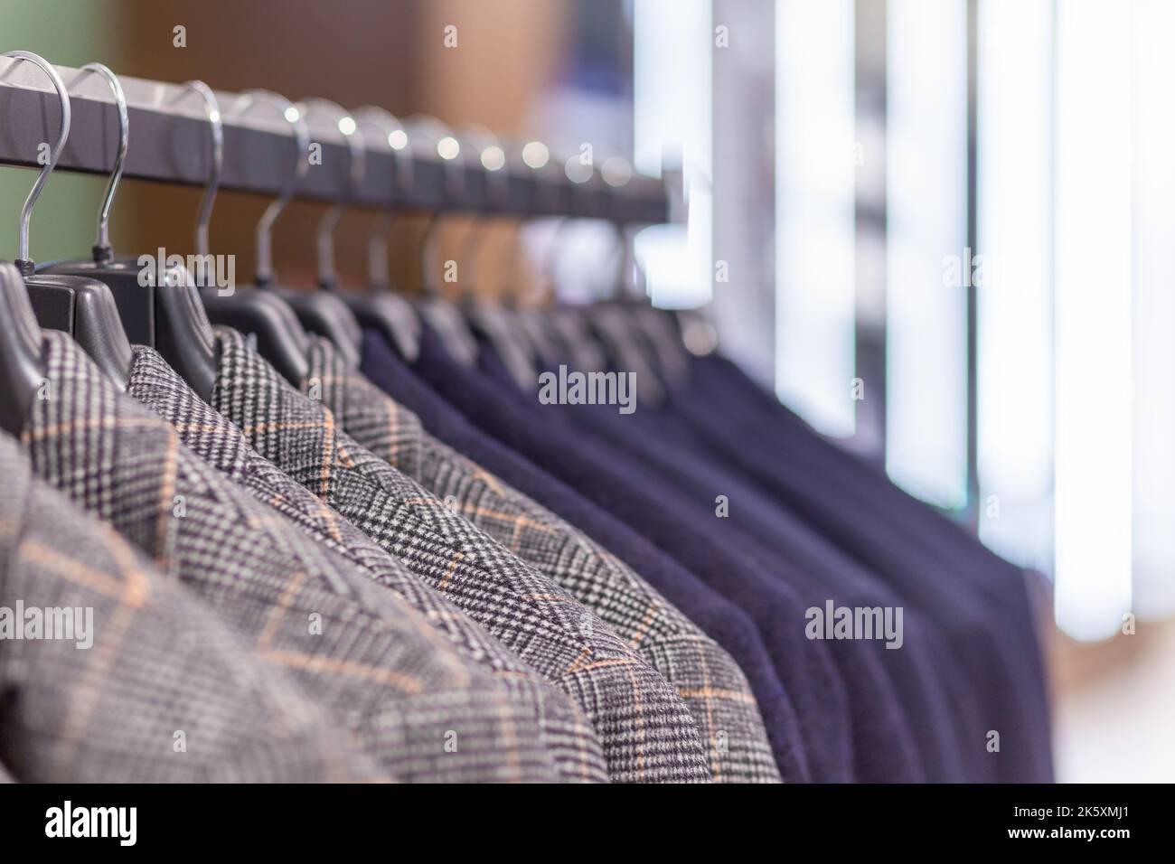 Racks with different men's suits in a men's clothing boutique. LED ...