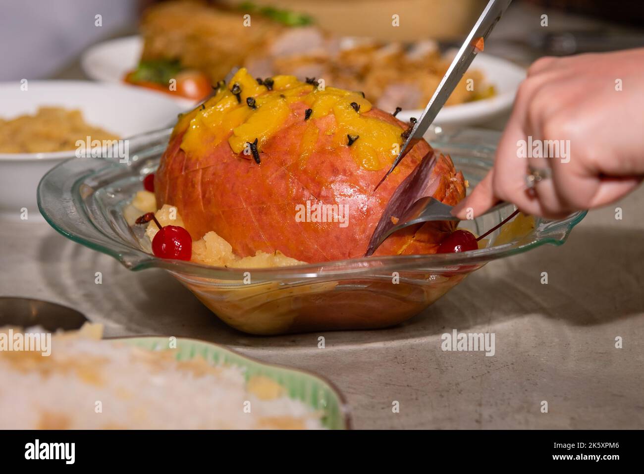 White female hand carving a smoked ham for a holiday dinner Stock Photo ...