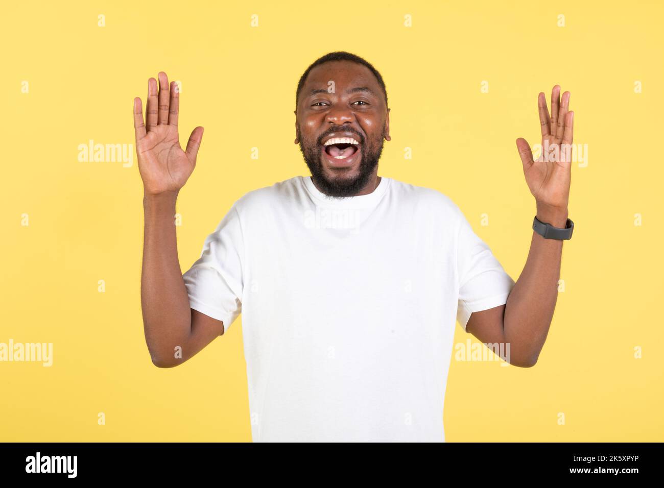 Excited Black Man Shouting In Joy Raising Arms, Yellow Background Stock ...