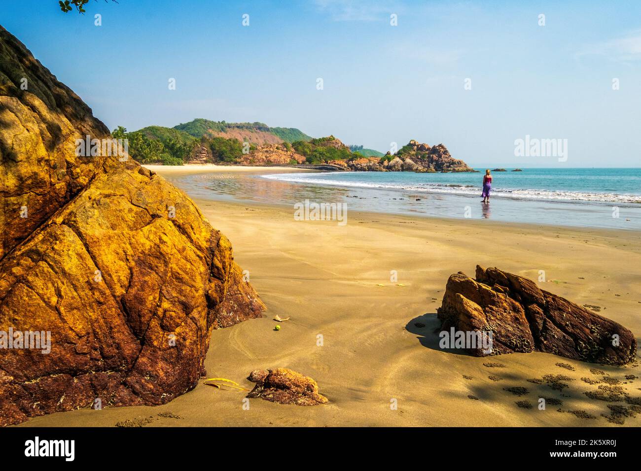 Female tourist on an empty beach amid Beautiful coastal scenery on the ...