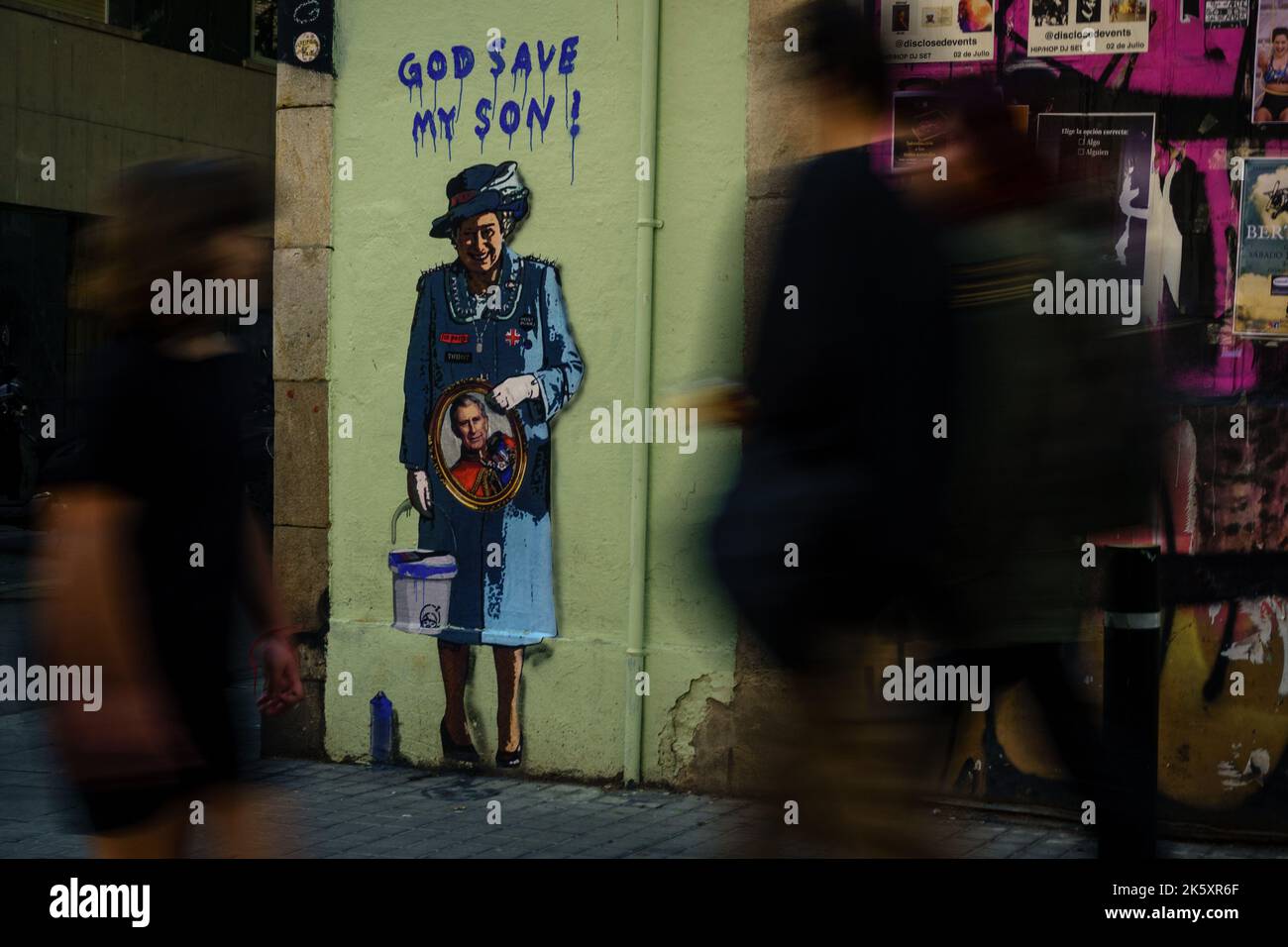 Barcelona, Spain. 10th Oct, 2022. Commuters walk past a graffiti by ...