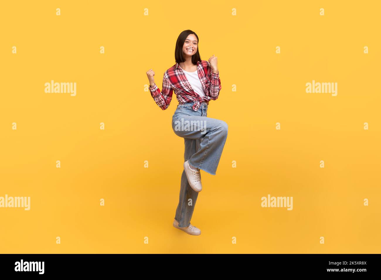 Excited asian lady celebrating success and jumping in air, happy having ...