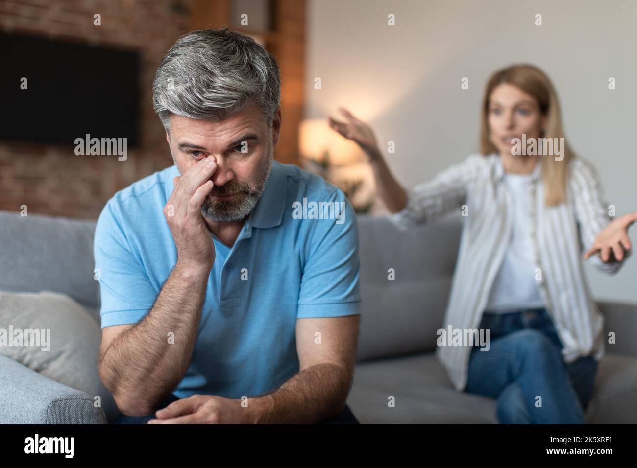 Angry middle aged european woman scolding at offended man during ...