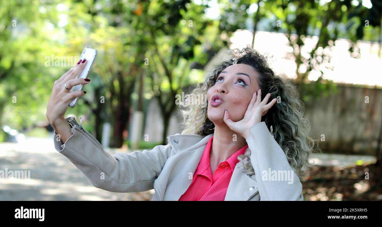 Woman taking selfie with phone camera outside of herself Stock Photo ...