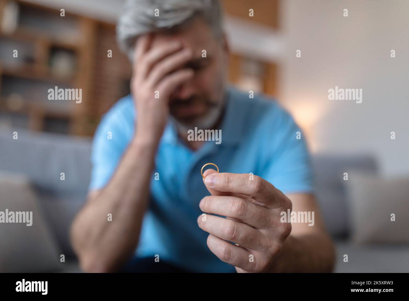 Despaired sad middle aged european man suffering from divorce, holds ...
